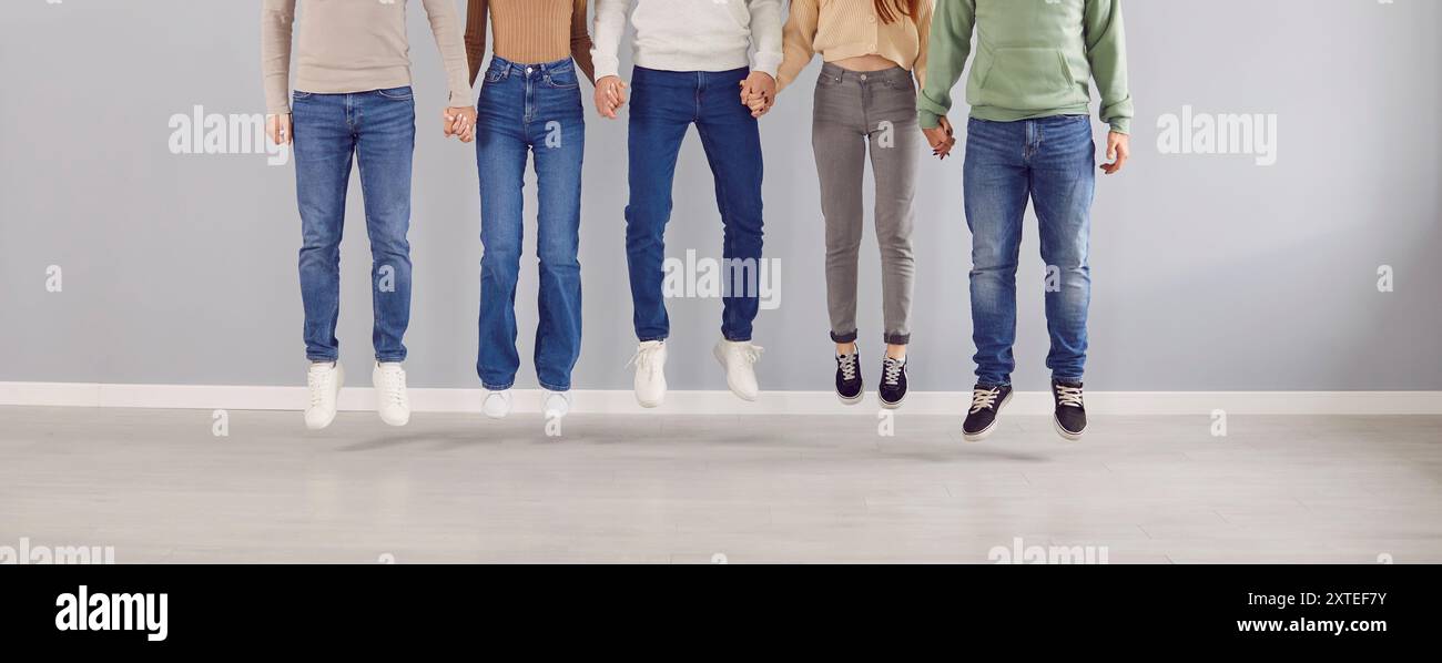 Legs close up people wearing jeans in jump movement, group hands ...