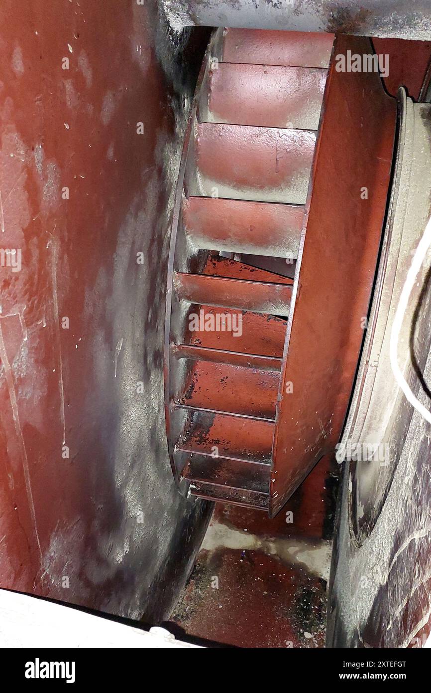 The impeller of an industrial exhaust fan shows signs of wear ...