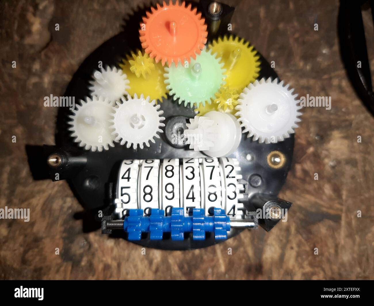 The water meter mechanism displays intricate gears and numerical dials ...