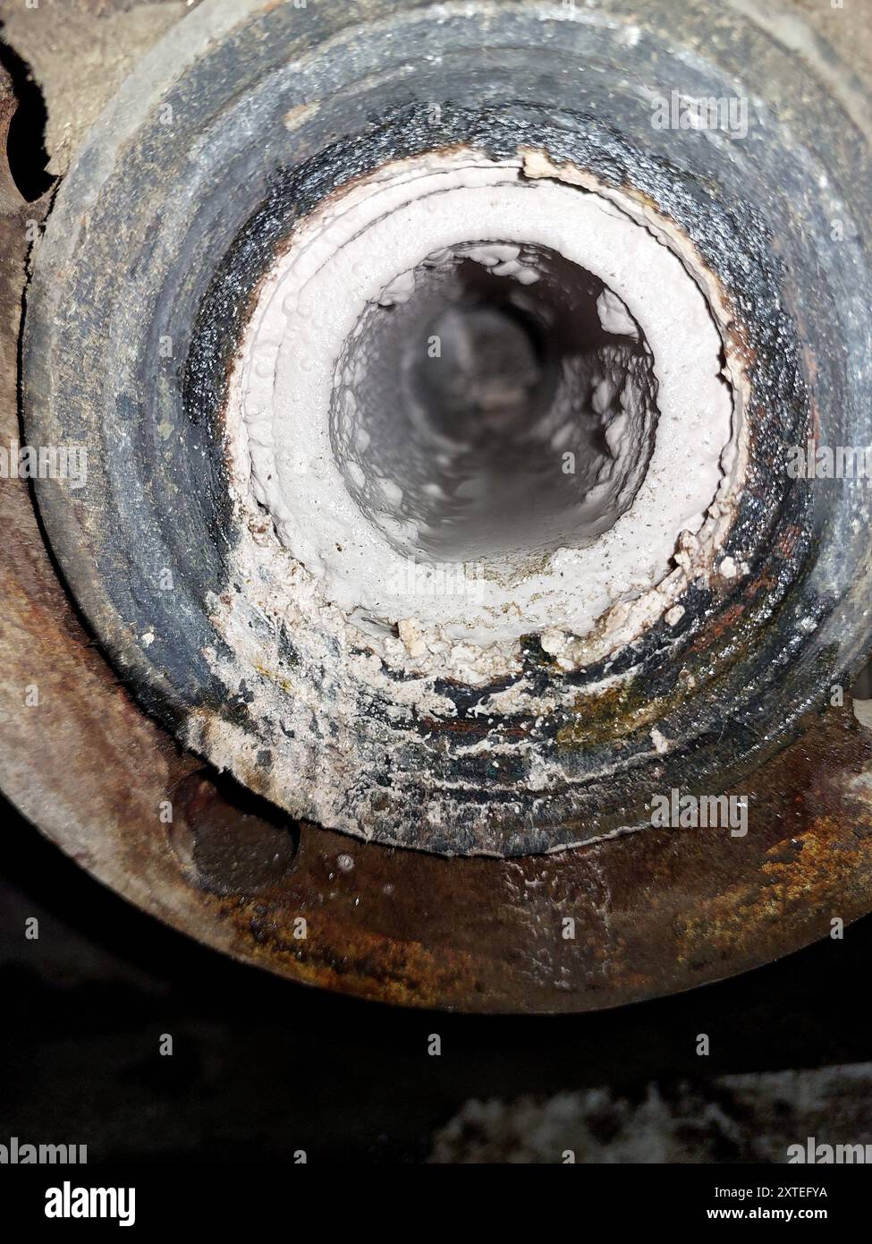 A close-up view of a pipe interior reveals significant limestone ...