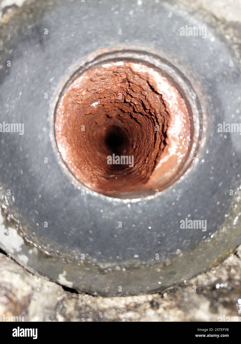 A close view reveals a pipe containing limestone deposits, highlighting ...