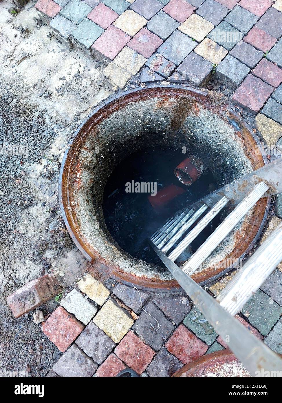 A sewage well is being repaired after the cobblestone surface collapsed ...