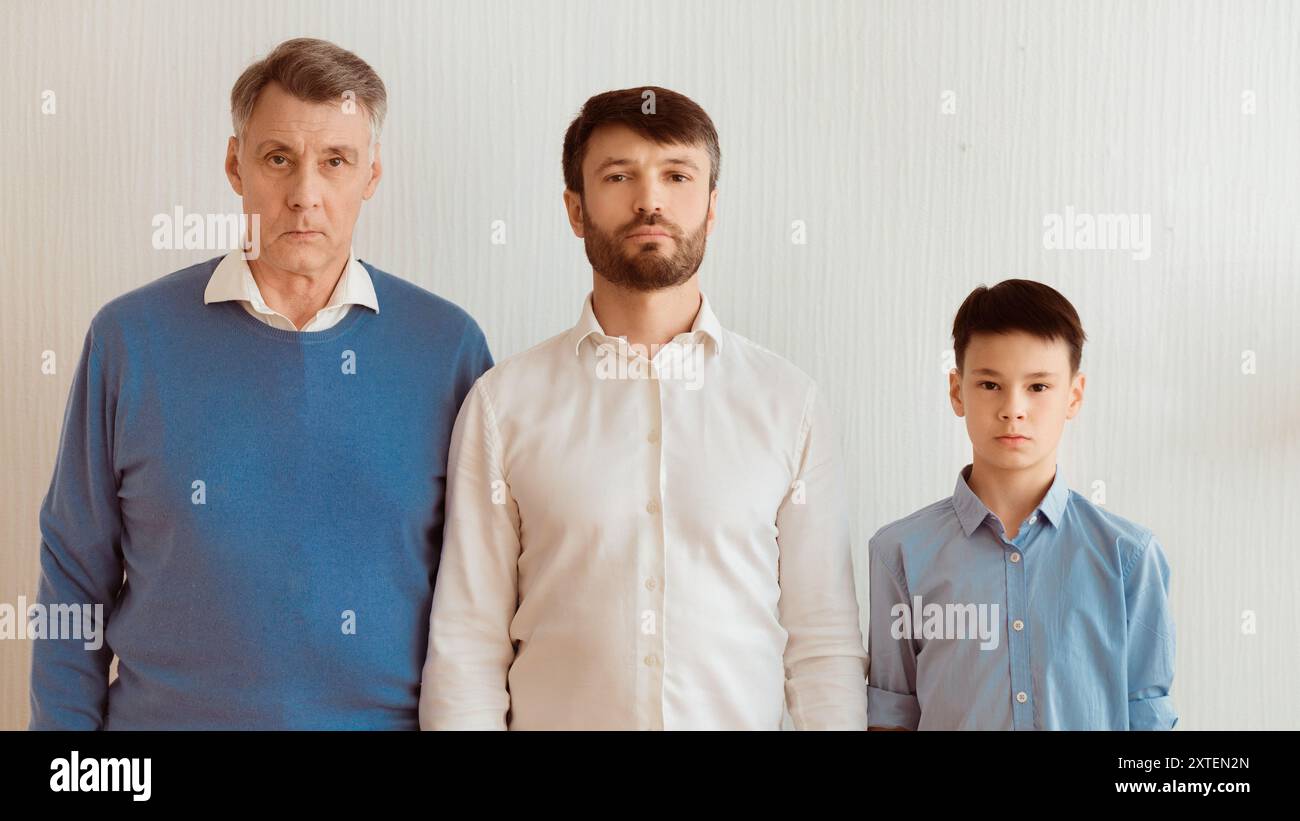 Boy, Father And Grandfather Standing Against White Wall Indoor ...