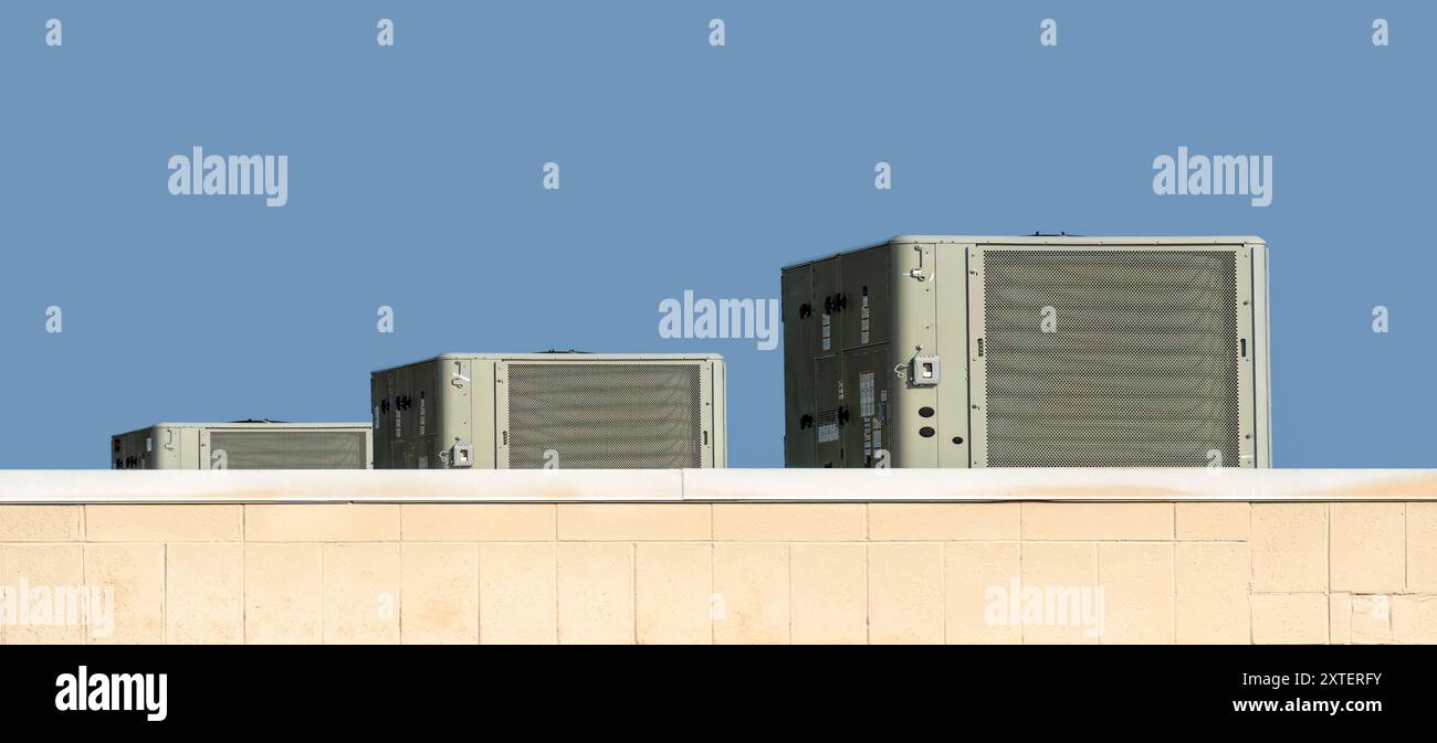 Horizontal shot of three commercial air conditioning units on the roof ...