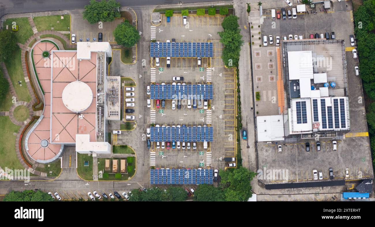 Big parking lot with solar panel roof ar residential district aerial ...