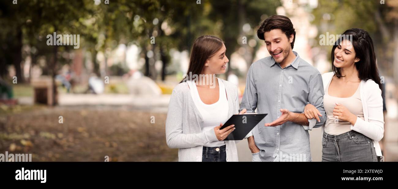 Girl Interviewing Young Couple Conducting Sociological Survey Standing ...