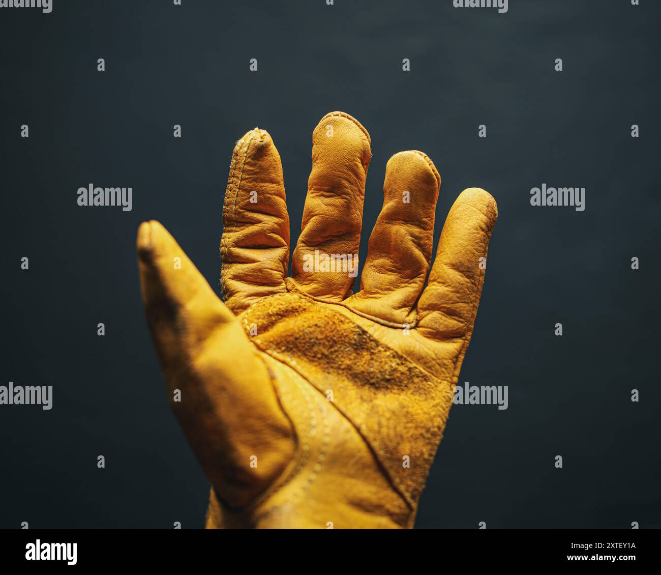 Open hand reaching out wearing an old worn work glove. Employment for ...