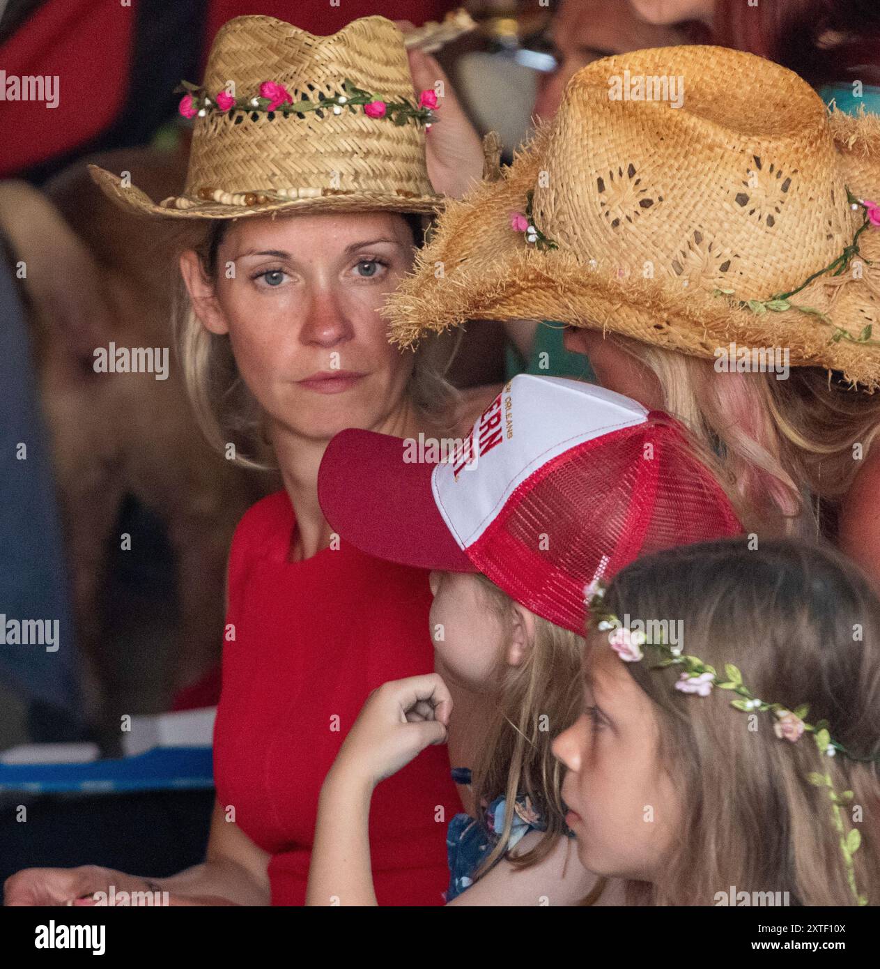 Woman in a red top and a straw cowboy hat at the Maverick Americana ...