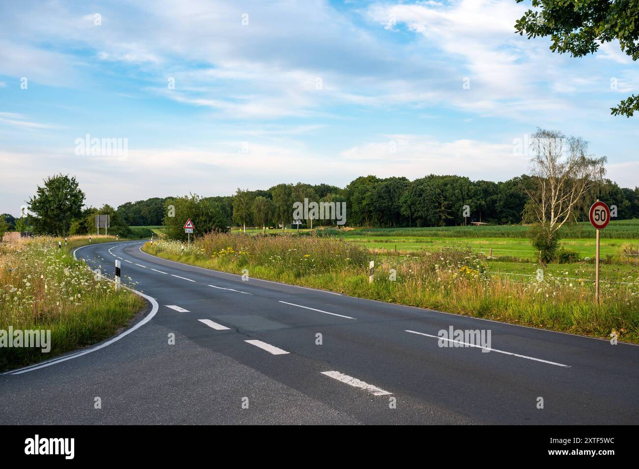 Asphalt road with intersection at the German countryside around ...