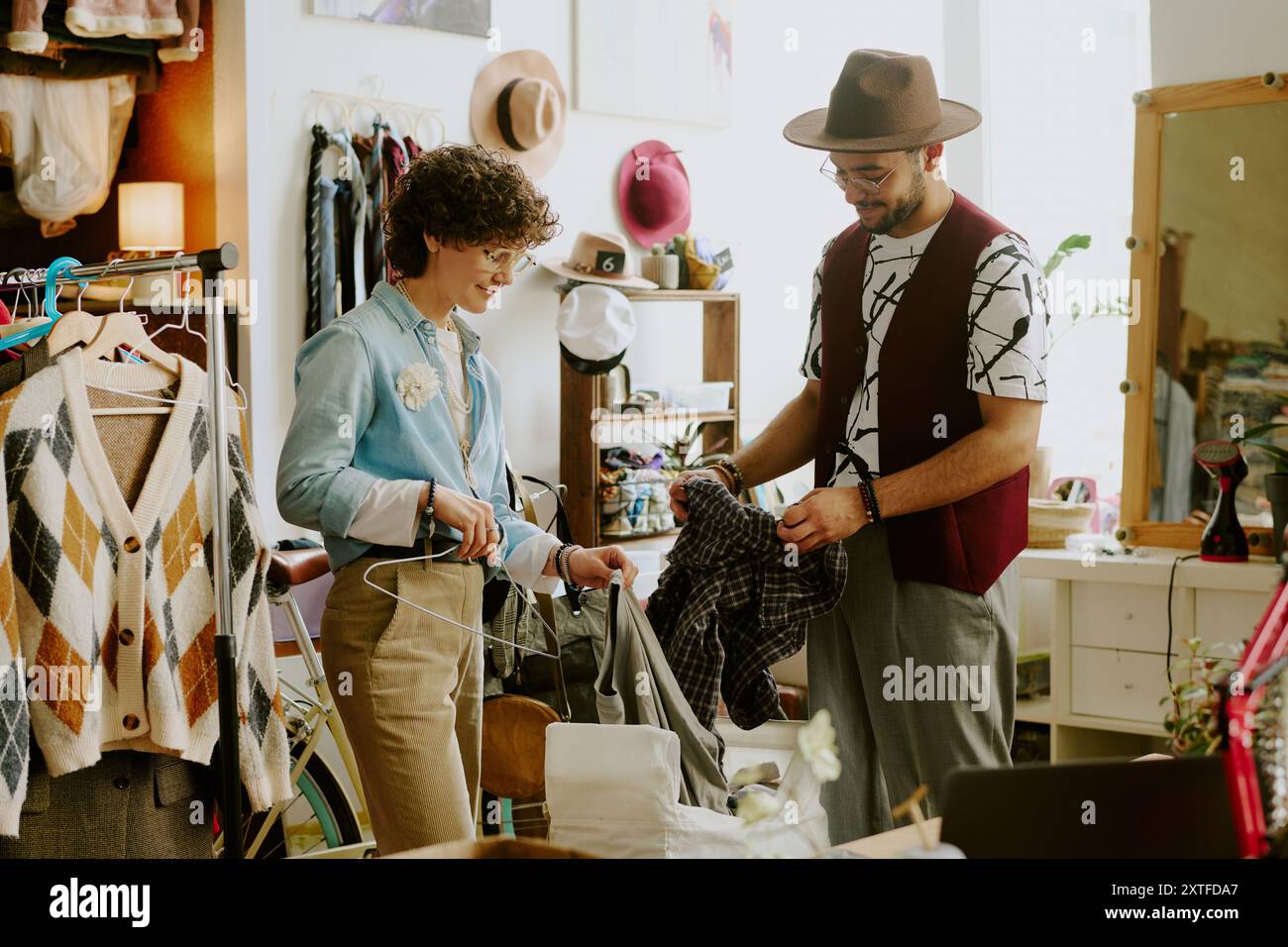 Sorting Clothes in Vintage Clothing Store with Shelves Stock Photo - Alamy