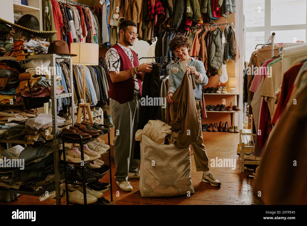 Choosing Clothes in Vintage Clothing Store Together Stock Photo - Alamy