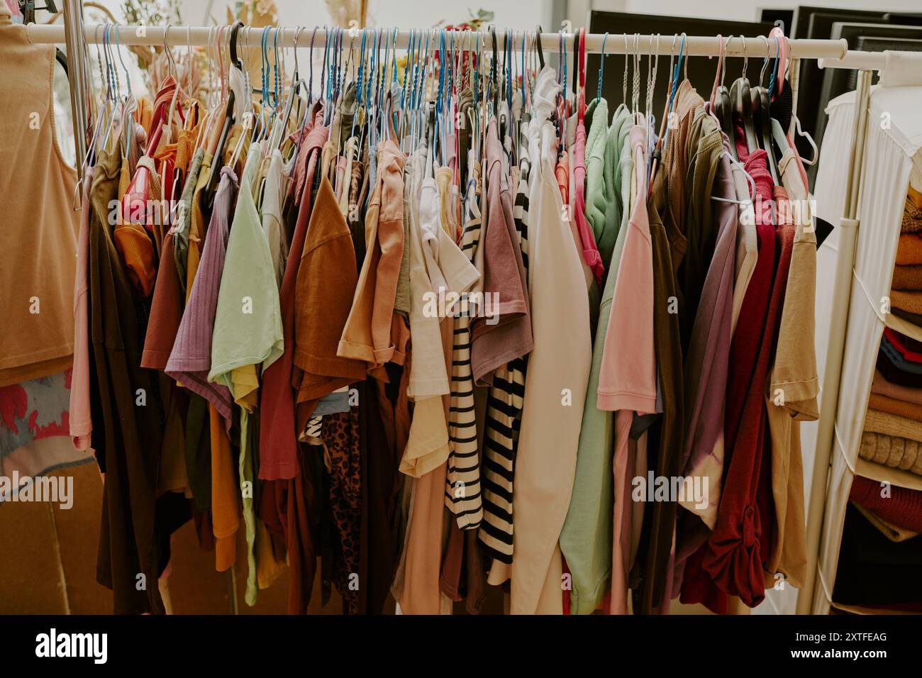 Varied Array of Clothes Hanging on Rack in Store Stock Photo - Alamy