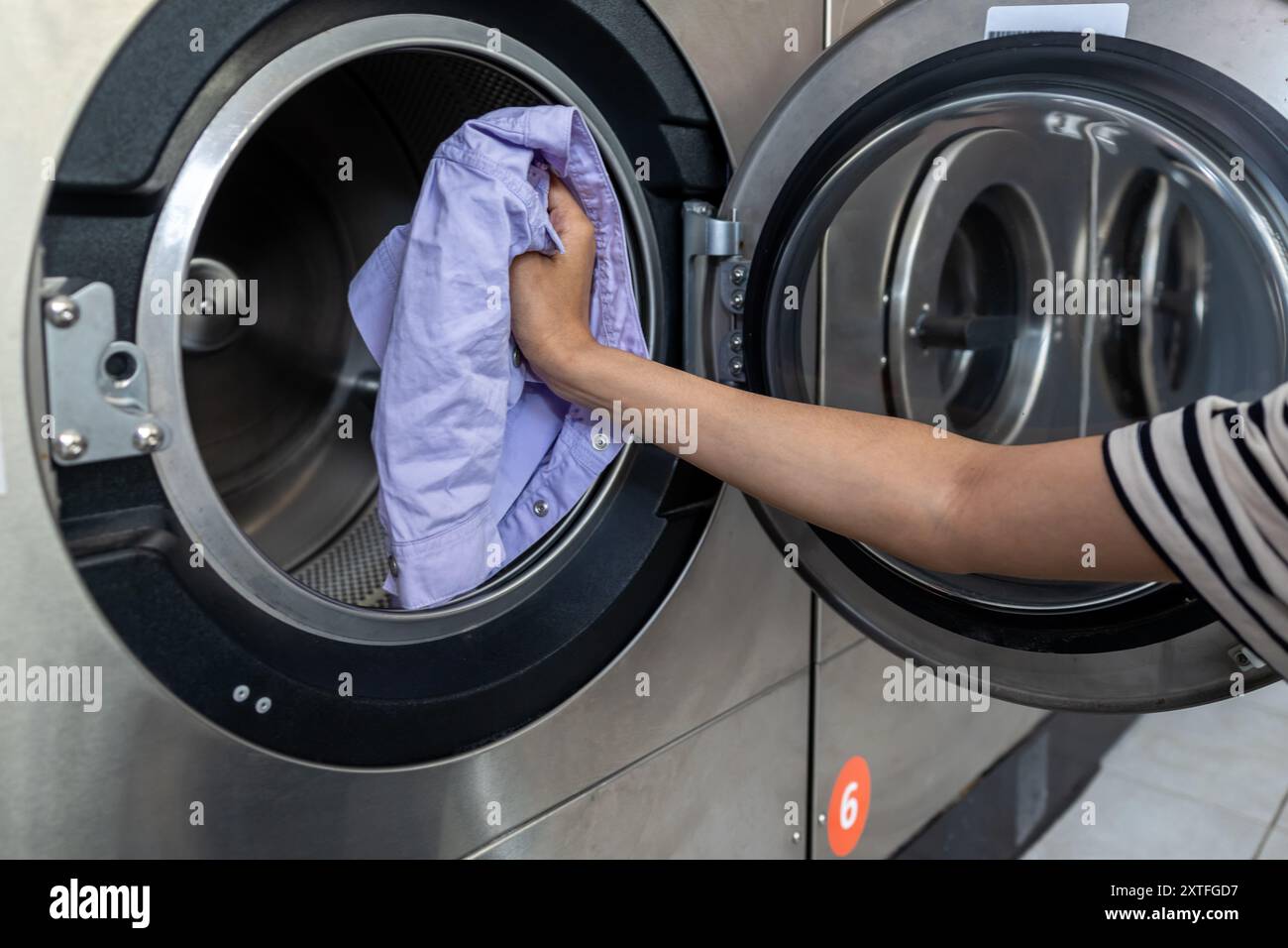 Unrecognizable woman housewife washing clothing at industrial ...