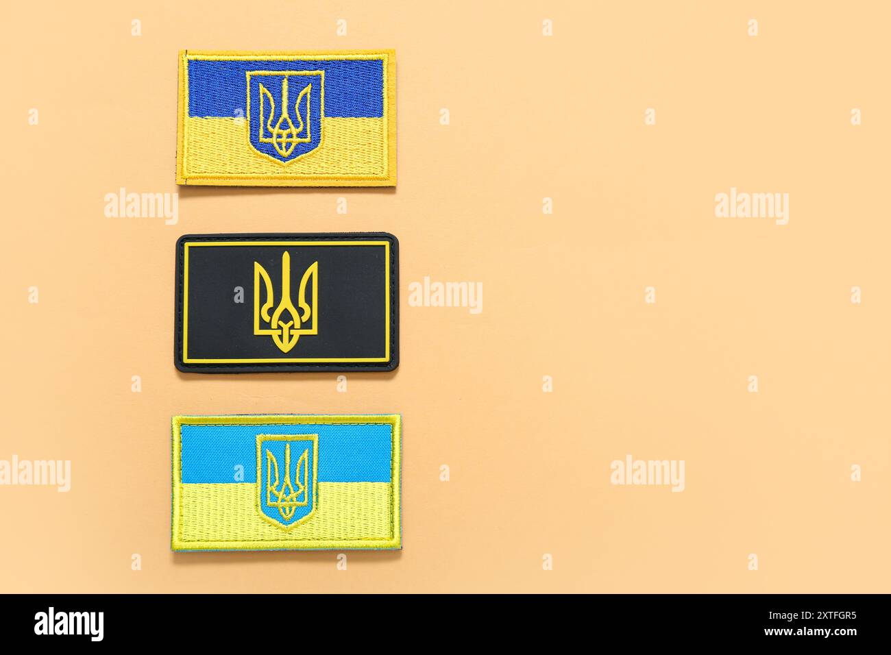 Different military badges of Ukrainian army with trident on beige ...