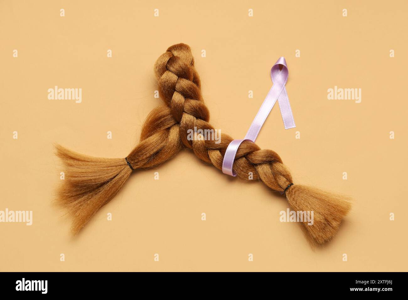 Braided red hair for donation with purple awareness ribbon on orange ...
