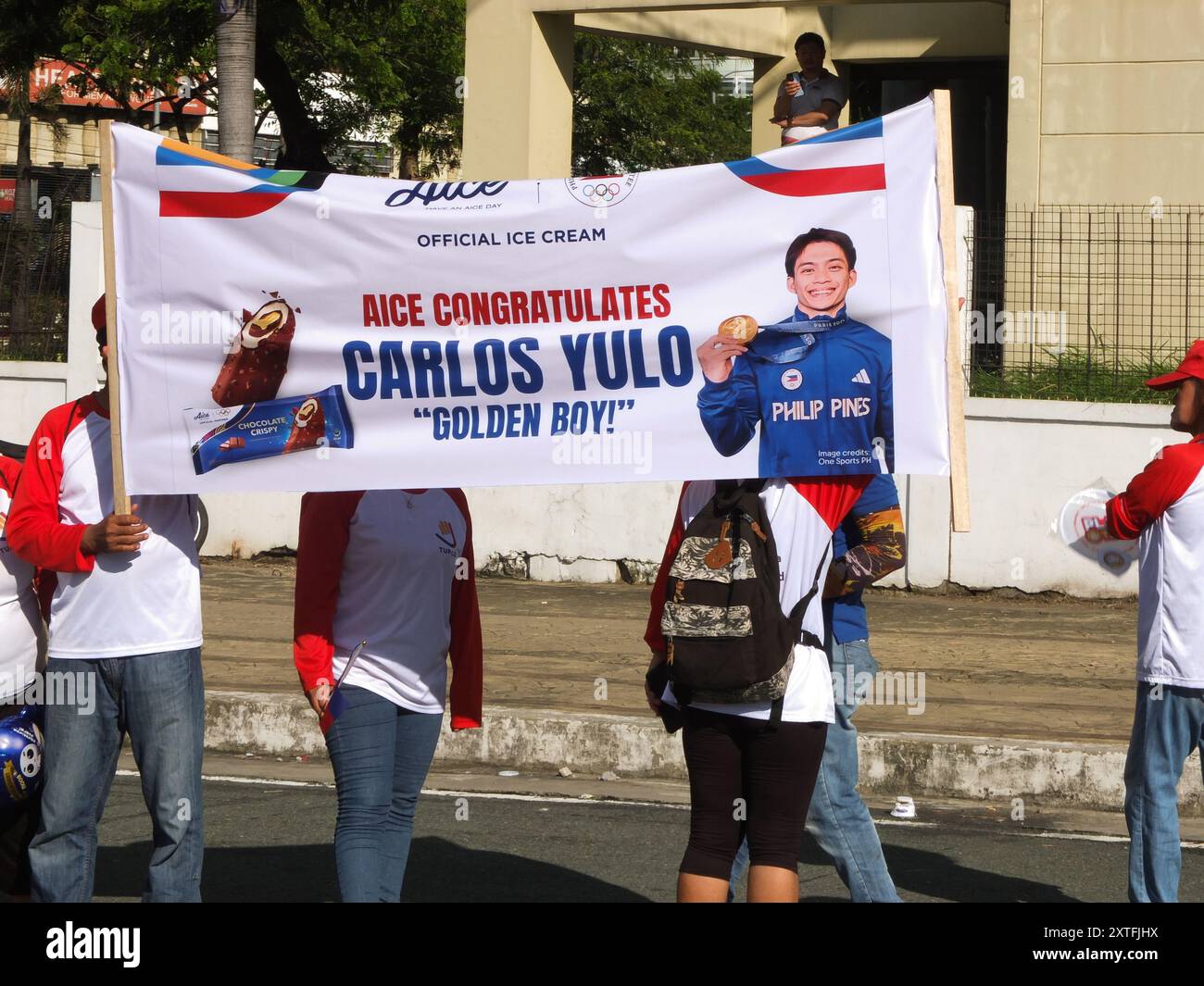 Filipino supporters carry a banner with picture of Philippine Gymnast ...
