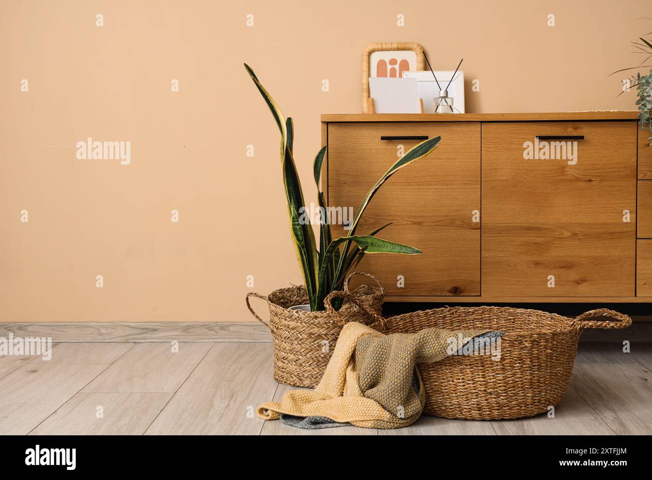 Aroma diffuser and photo frames on chest of drawers in modern living ...