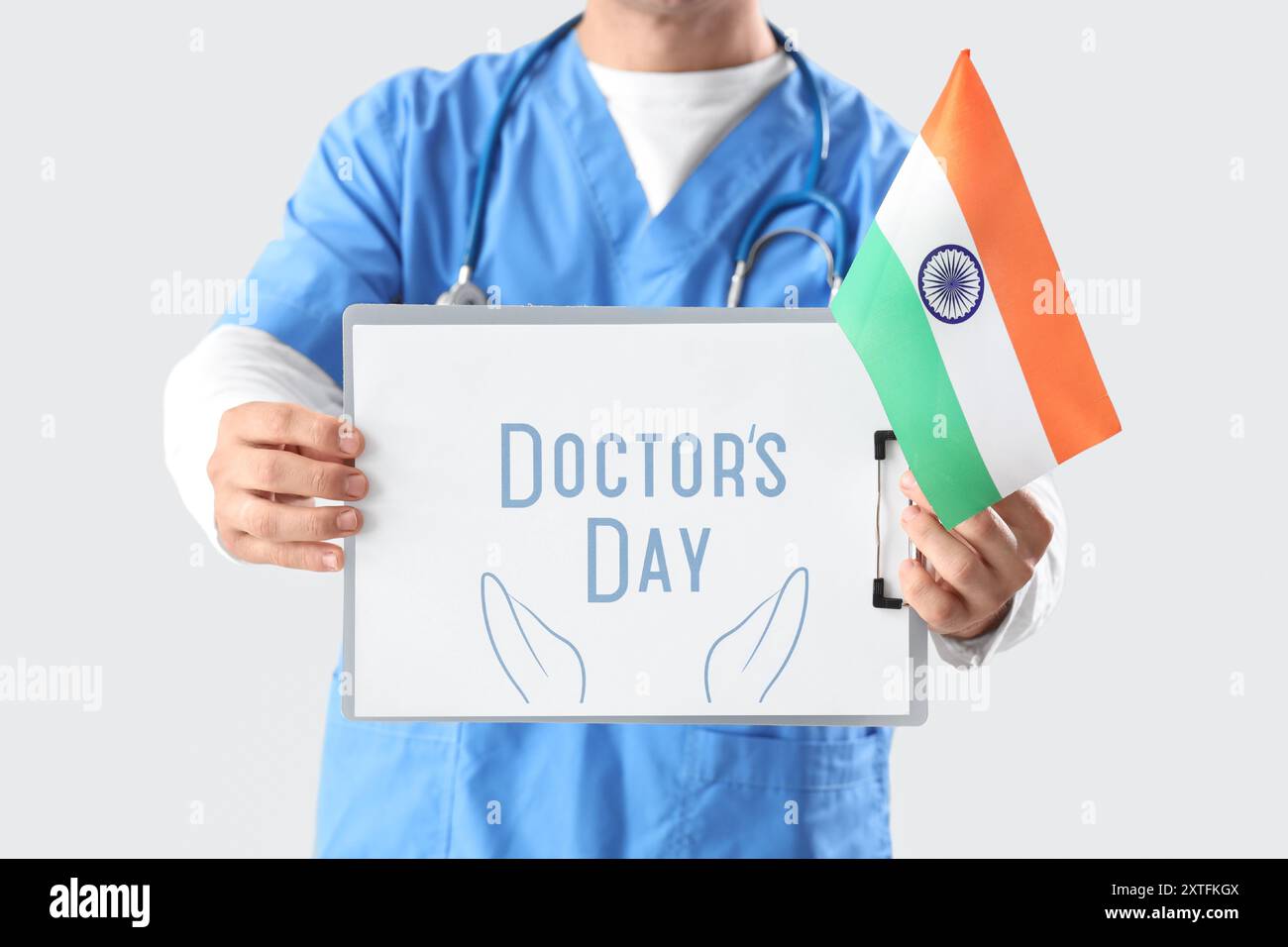Male doctor holding flag of India and clipboard with text DOCTOR'S DAY ...