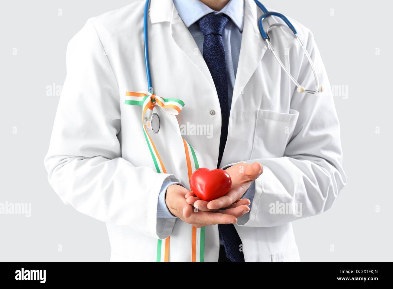 Male doctor heart and ribbon in colors of Indian flag on grey ...