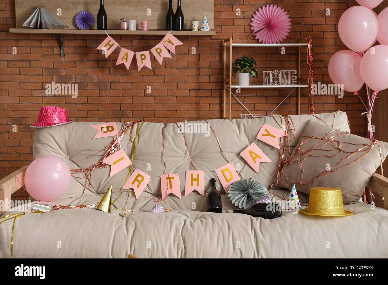 Sofa with bottles and party decor in messy living room after Birthday ...