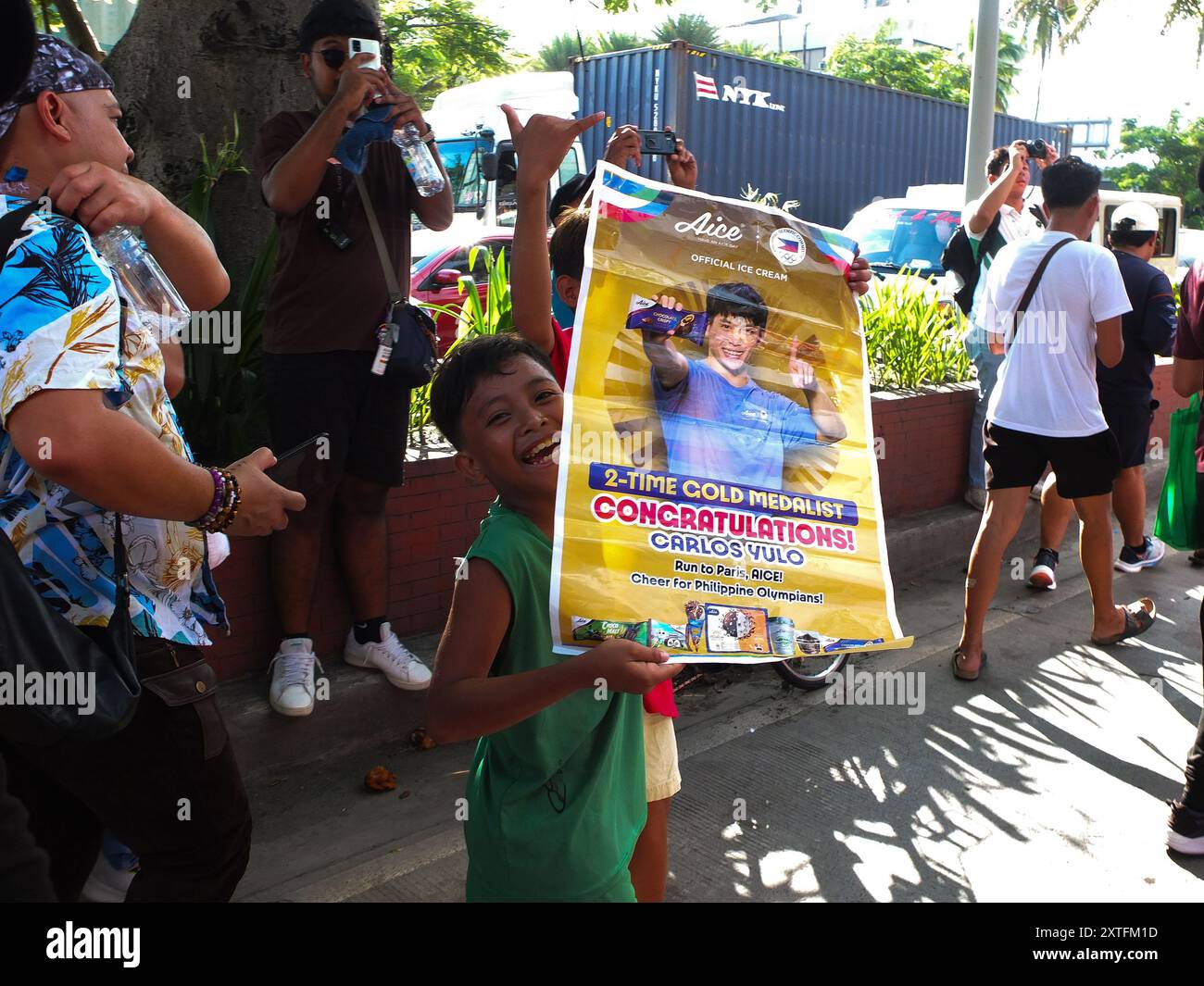 Manila, Philippines. 14th Aug, 2024. A young boy holds a poster of ...