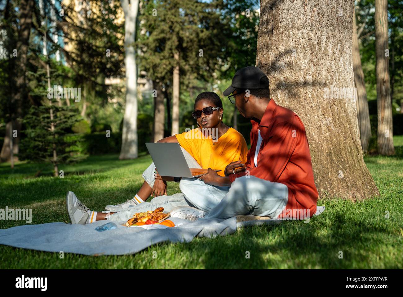 Concentrated black student friends remotely study for exams, discussing ...