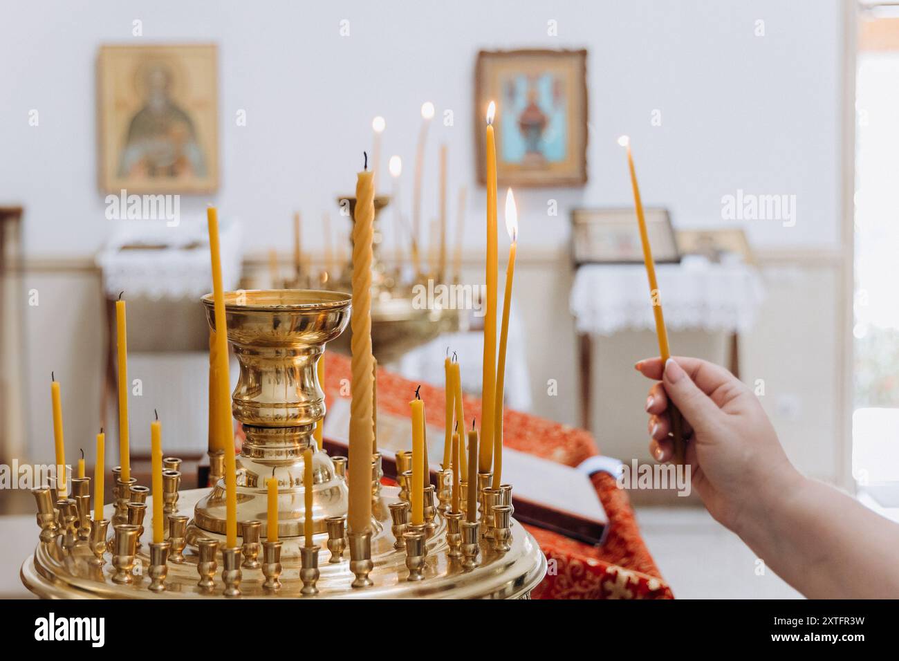 Lighting candles in a church ceremony, symbolizing faith, prayer, and ...
