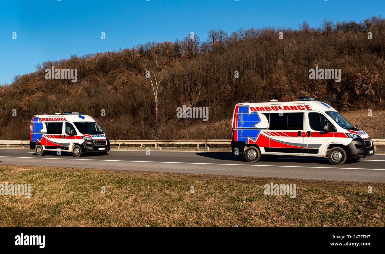 Two ambulance vans speeding on a highway at sunset. Ambulance cars ...