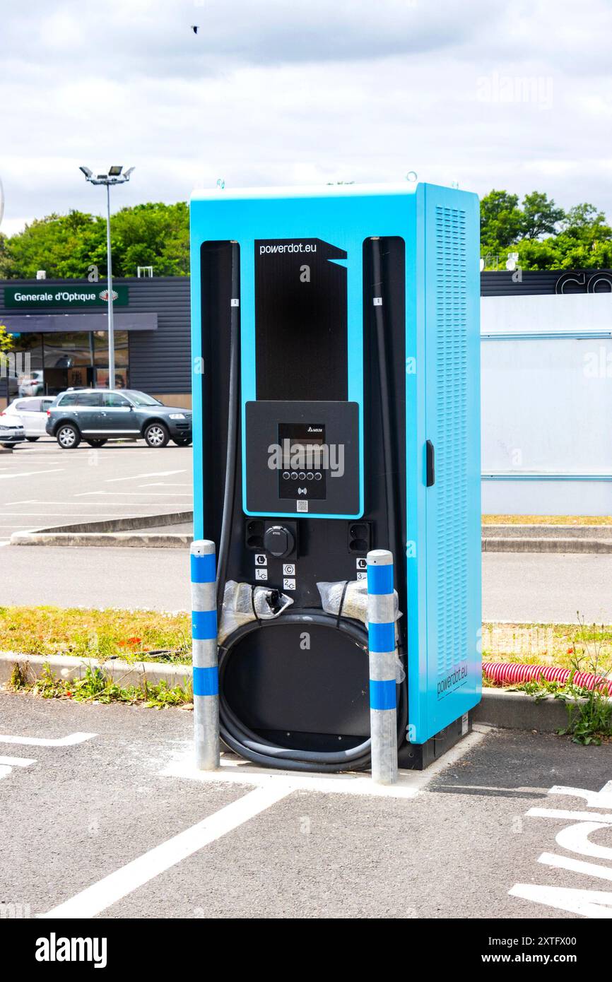 Electric vehicle charging station in a parking lot on a cloudy day ...
