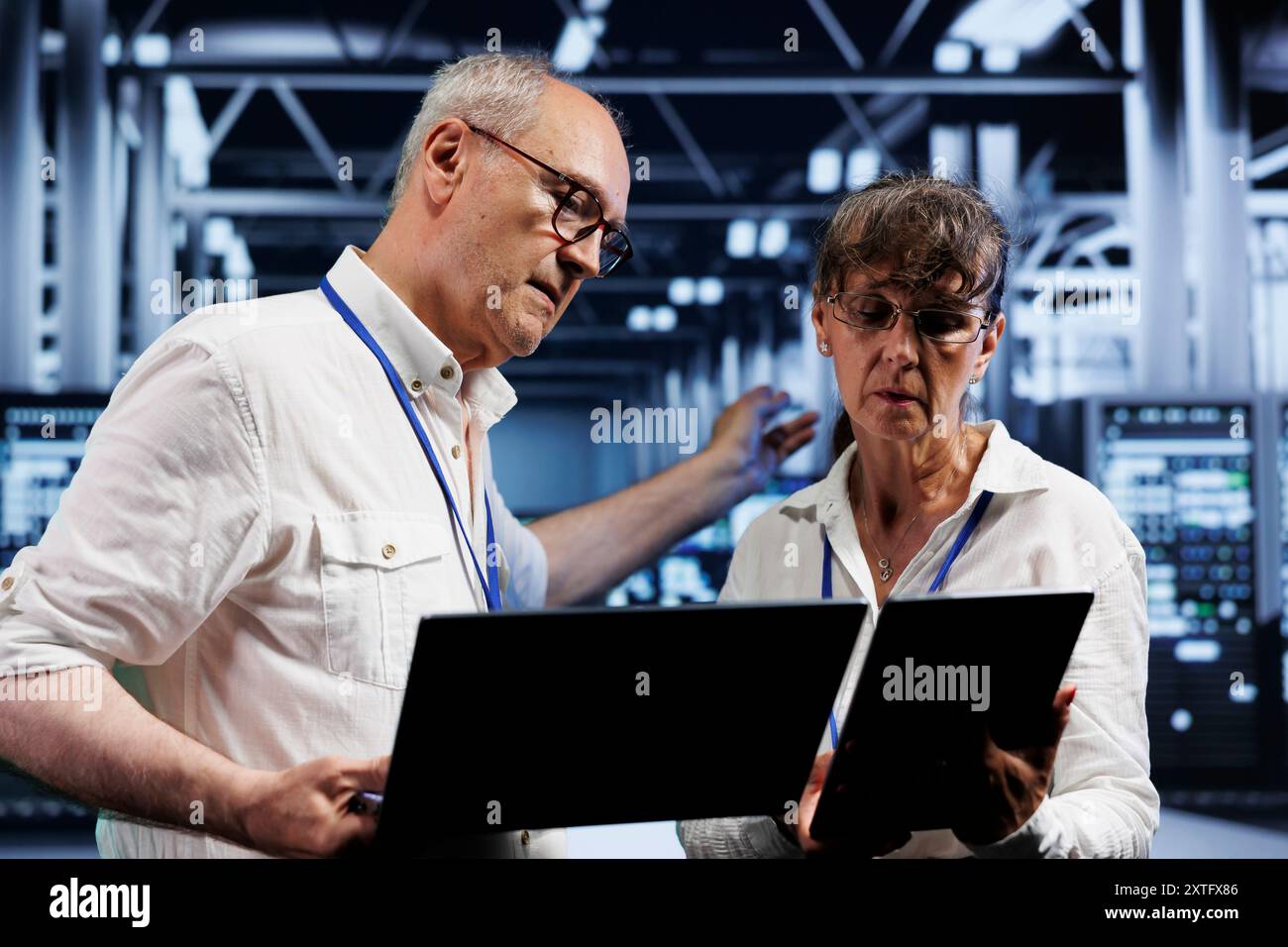 Computer scientists performing diagnostic assessments on server rigs to detect problems with ...