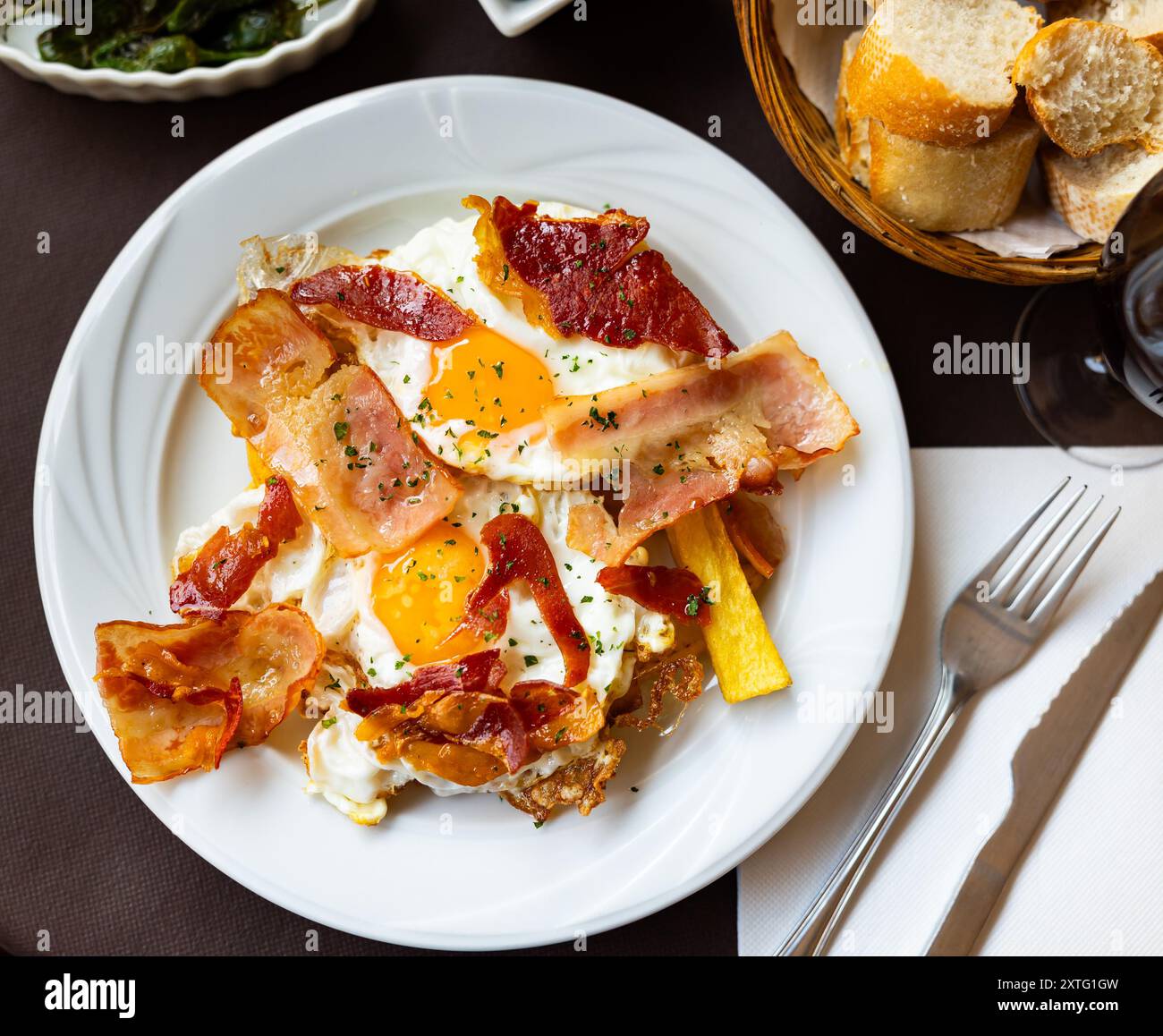 Homemade hearty breakfast - fried eggs with bacon and French fries ...