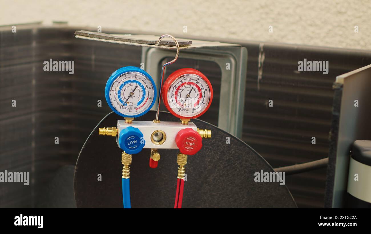 Close up of manifold meters used for checking air conditioner freon in ...