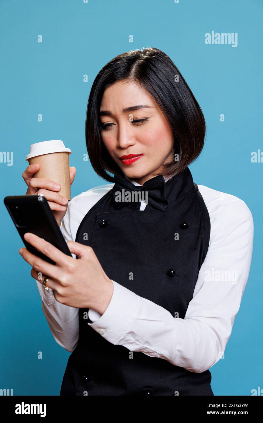 Hotel asian woman receptionist enjoying break while chatting on ...