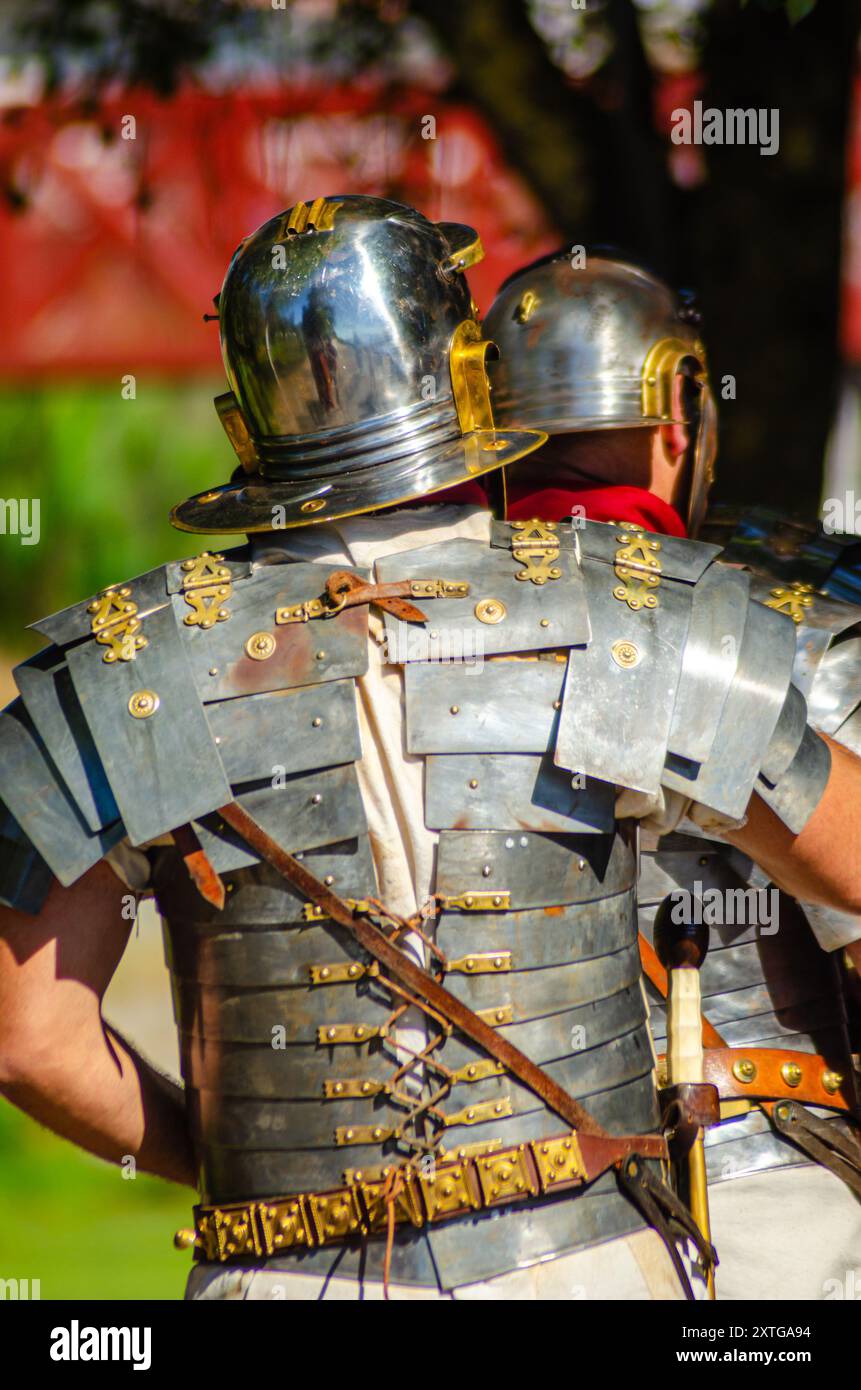 back view of Roman legionaries in metal armour at a historical ...
