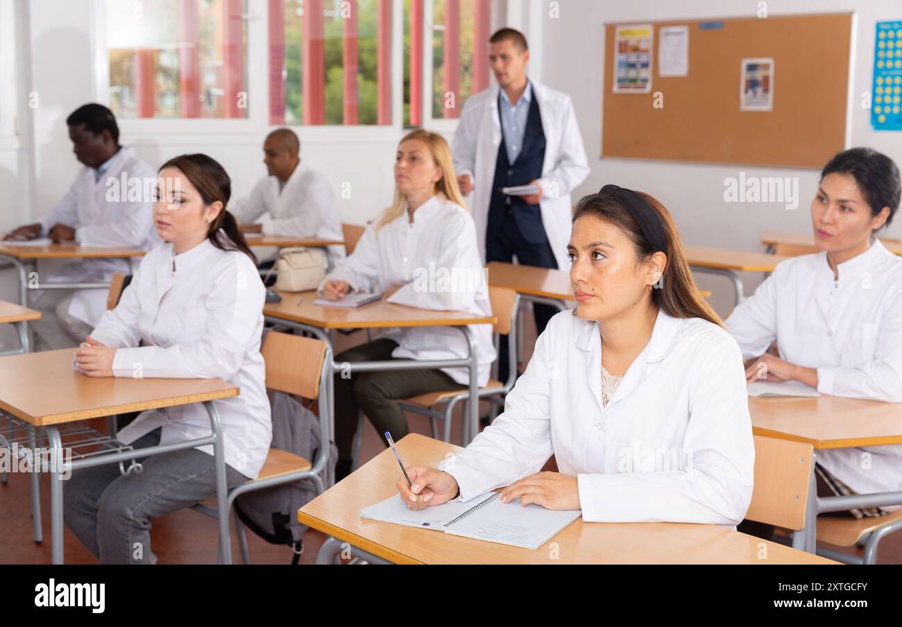 Medical students writing in notepads lesson Stock Photo - Alamy
