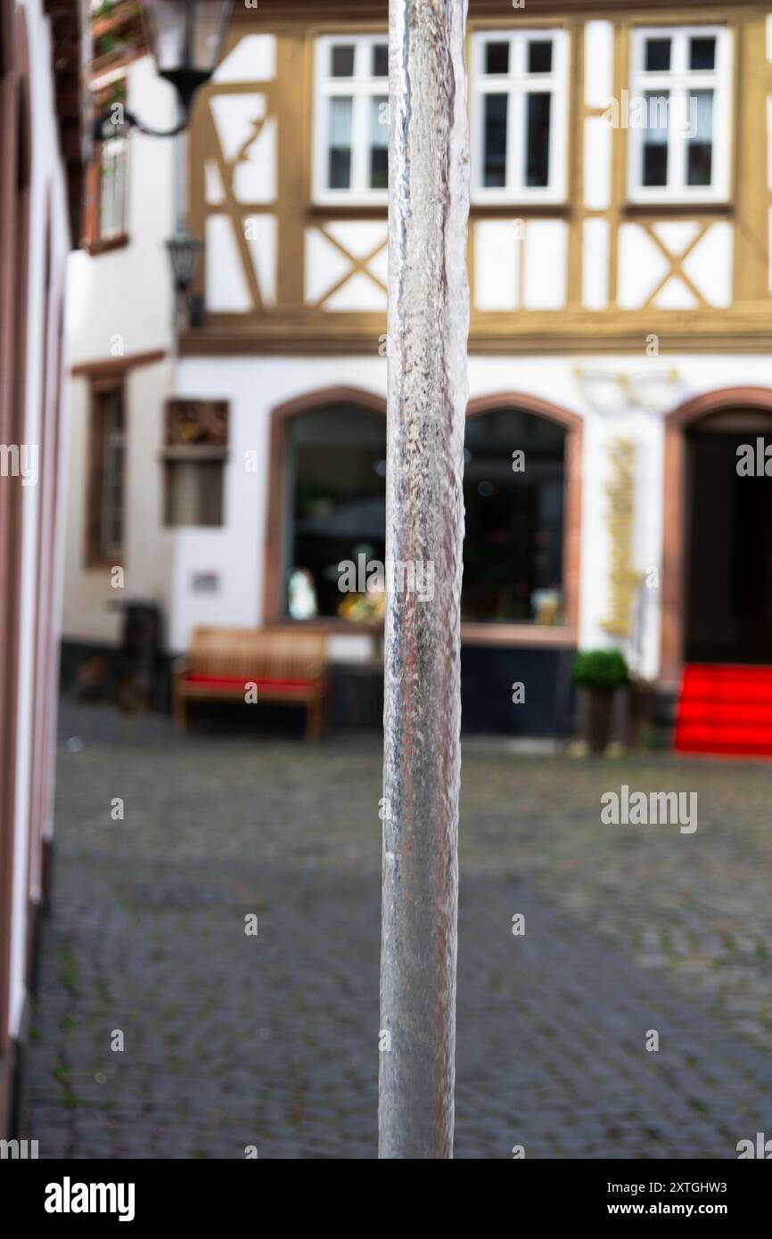 Water jet with a german timber framed house in the background. Mainz ...