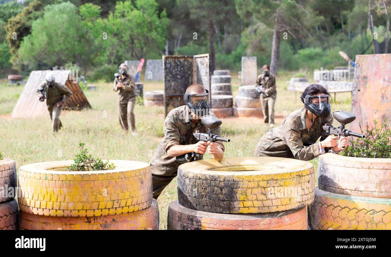 Paintball players of opposite teams in shootout Stock Photo - Alamy