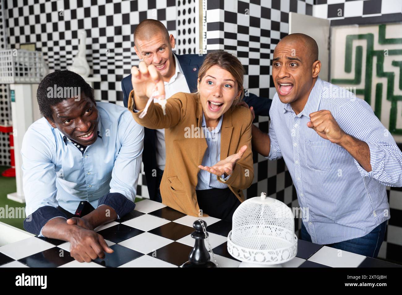 Four friends solving puzzles in quest room Stock Photo - Alamy