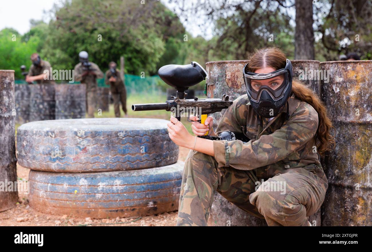 Team of friends paintball players playing together in battle Stock ...