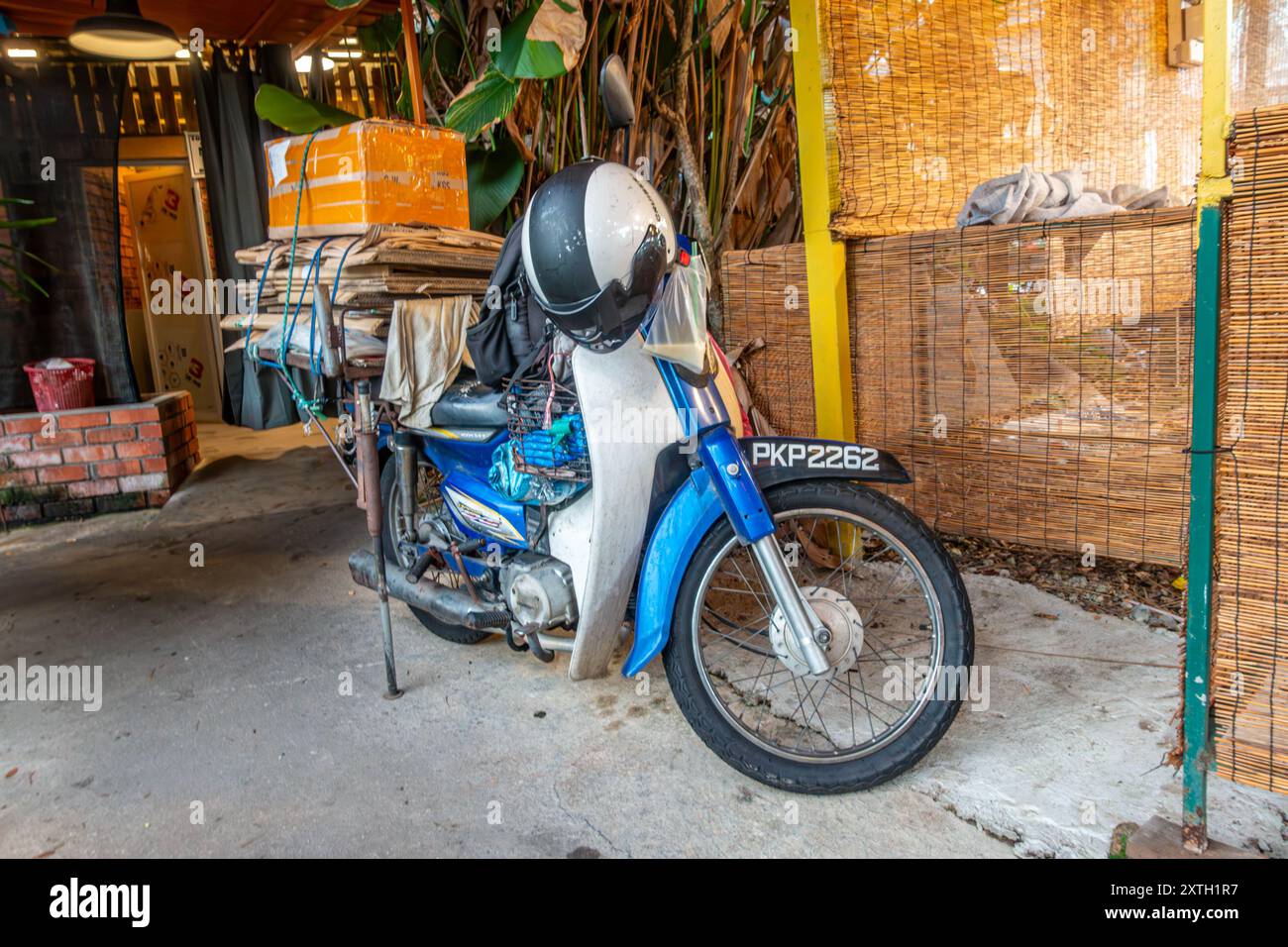 A motor scooter loaded up ready to transport flattened cardboard and a ...