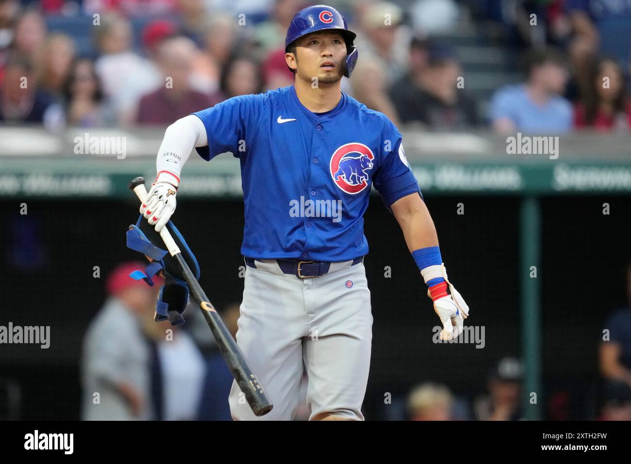 Chicago Cubs' Seiya Suzuki takes off his batting gear after drawing a ...