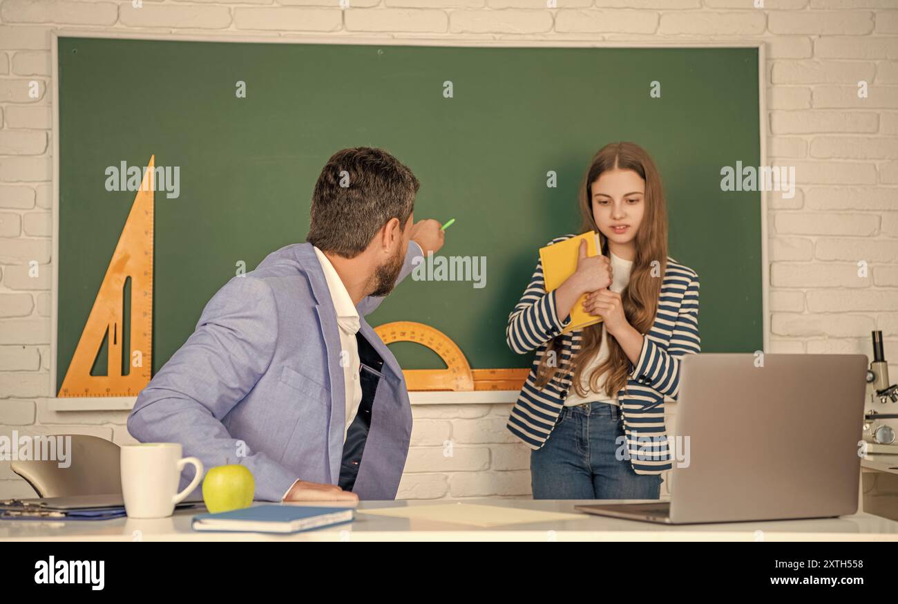 shouting school teacher with selective focus of child at blackboard ...