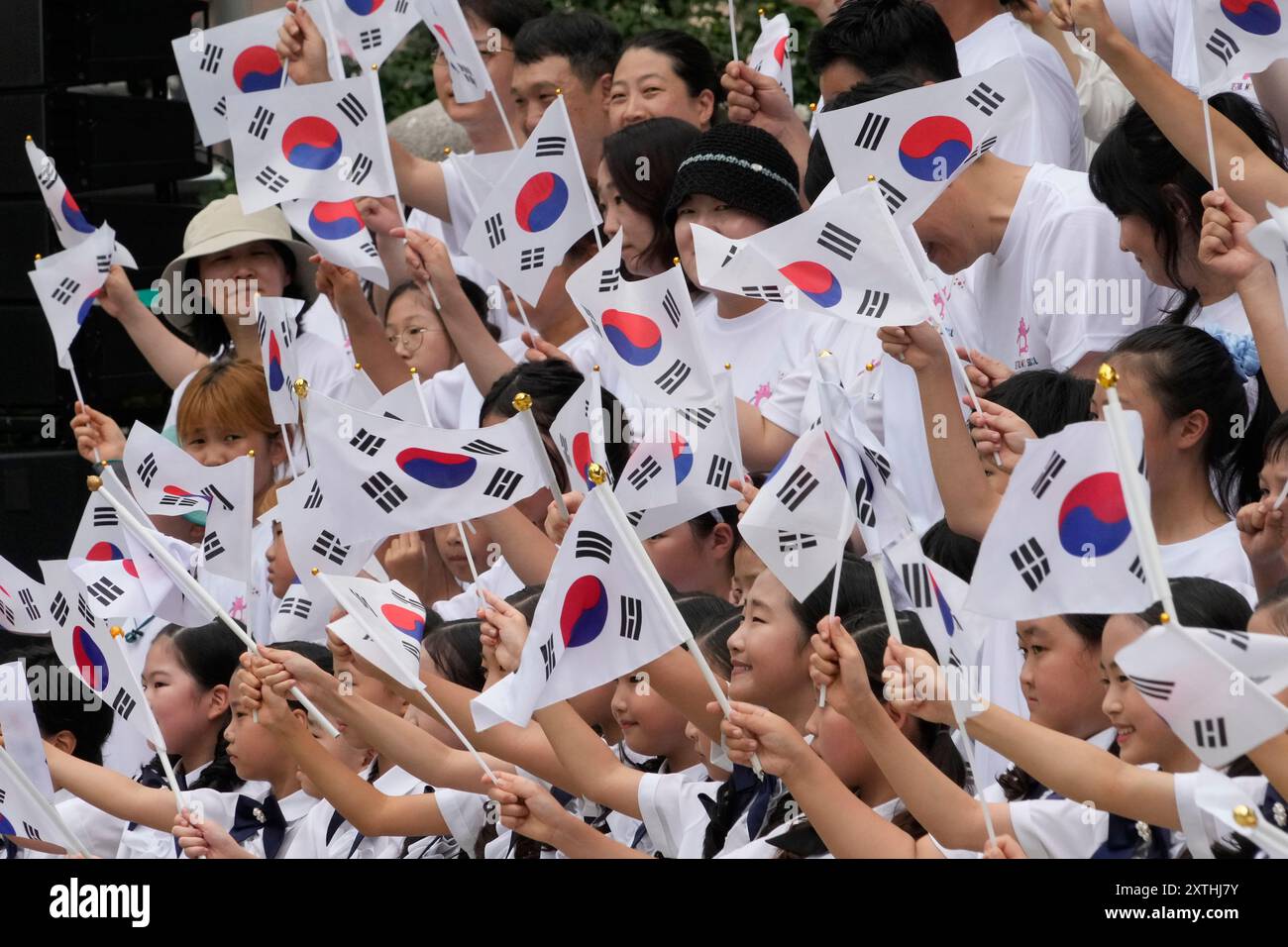 South Koreans wave the national flags during a ceremony to celebrate ...