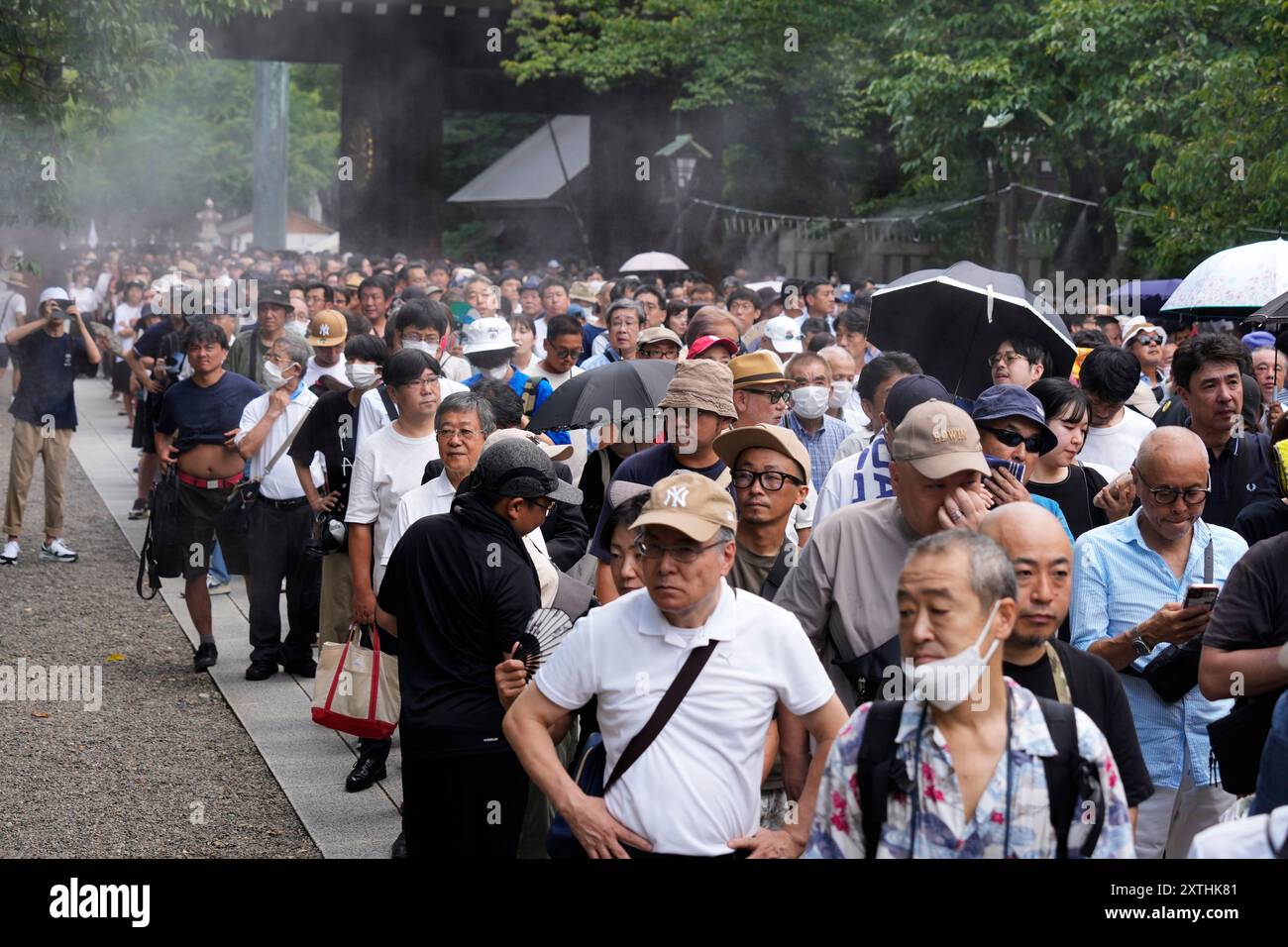 People wait in queue before reaching to the main hall to pray at ...