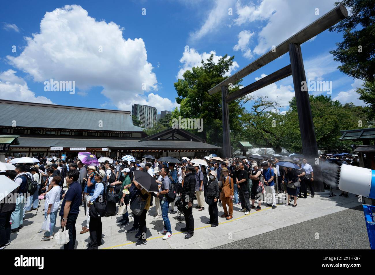 People wait in queue before reaching to the main hall to pray at ...