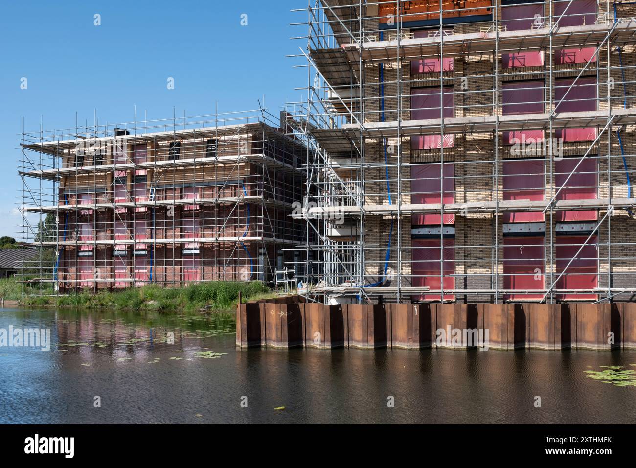 Scaffolding with platforms against a new-build apartment complex on a ...