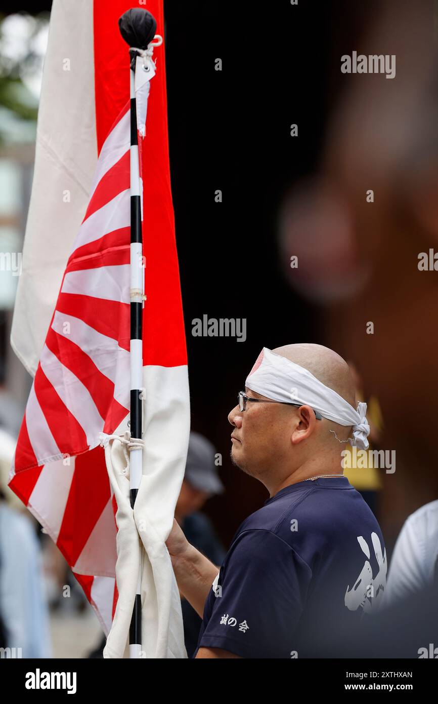 Tokyo, Japan. 15th Aug, 2024. Japanese nationalists holding war flags ...