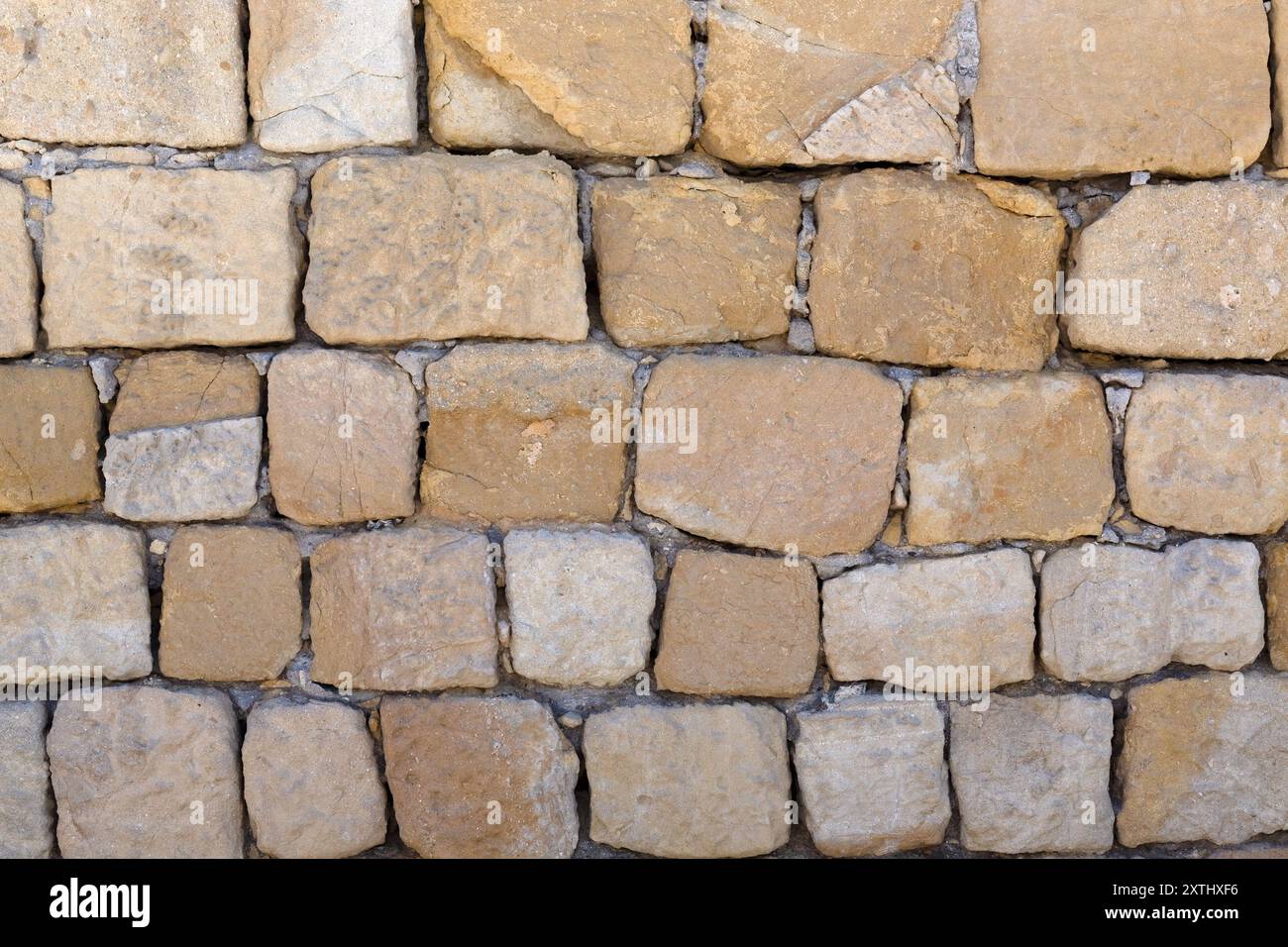 Background texture of warm coloured stone blocks in a wall Stock Photo ...