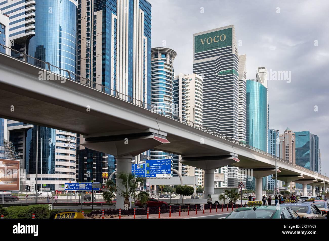 Sheikh Zayed road traffic day with skyscrapers. Line of Dubai Metro UAE ...