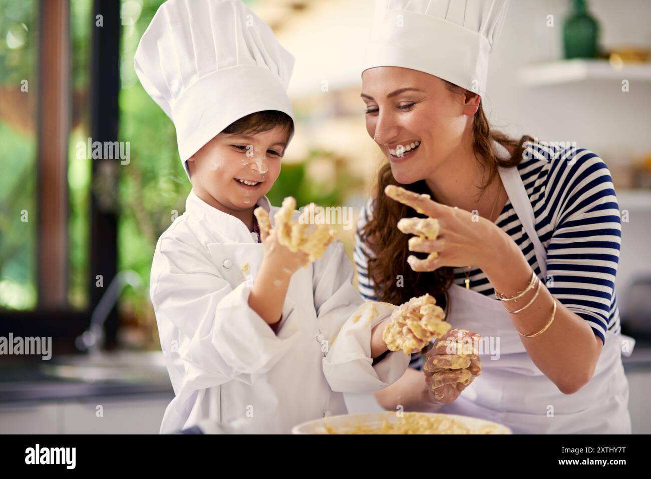 Mom, boy and dough for baking as chef in kitchen for role play, fun and ...